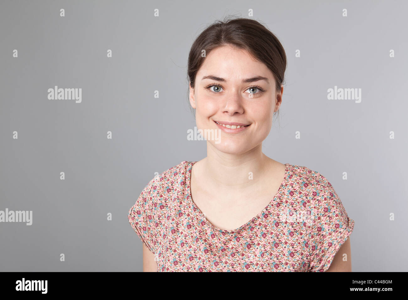 A cheerful young woman smiling at the camera, portrait Stock Photo - Alamy