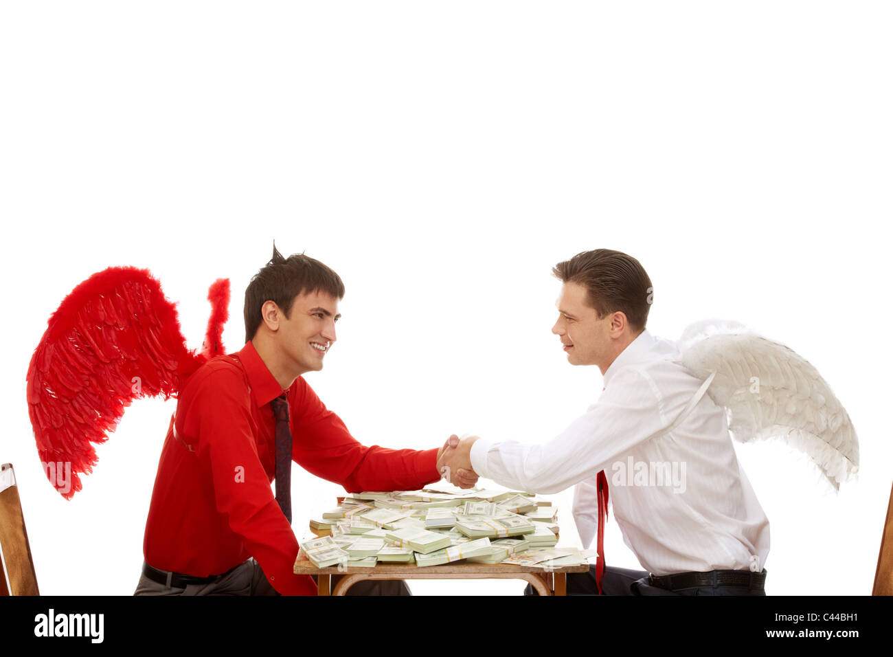 Image of deal between god and devil over table with dollars Stock Photo ...