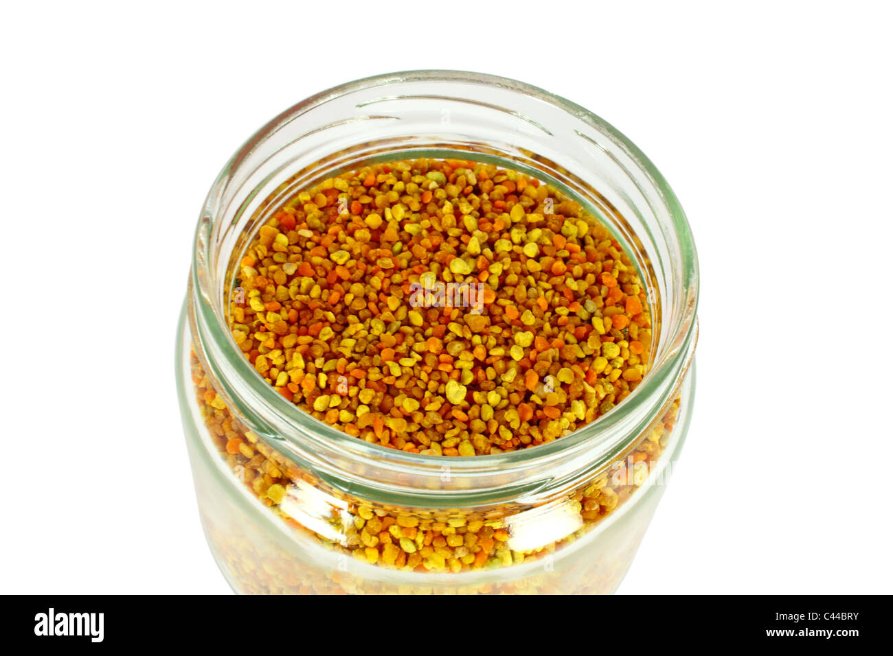 Bee pollen in glass jar isolated on white Stock Photo - Alamy