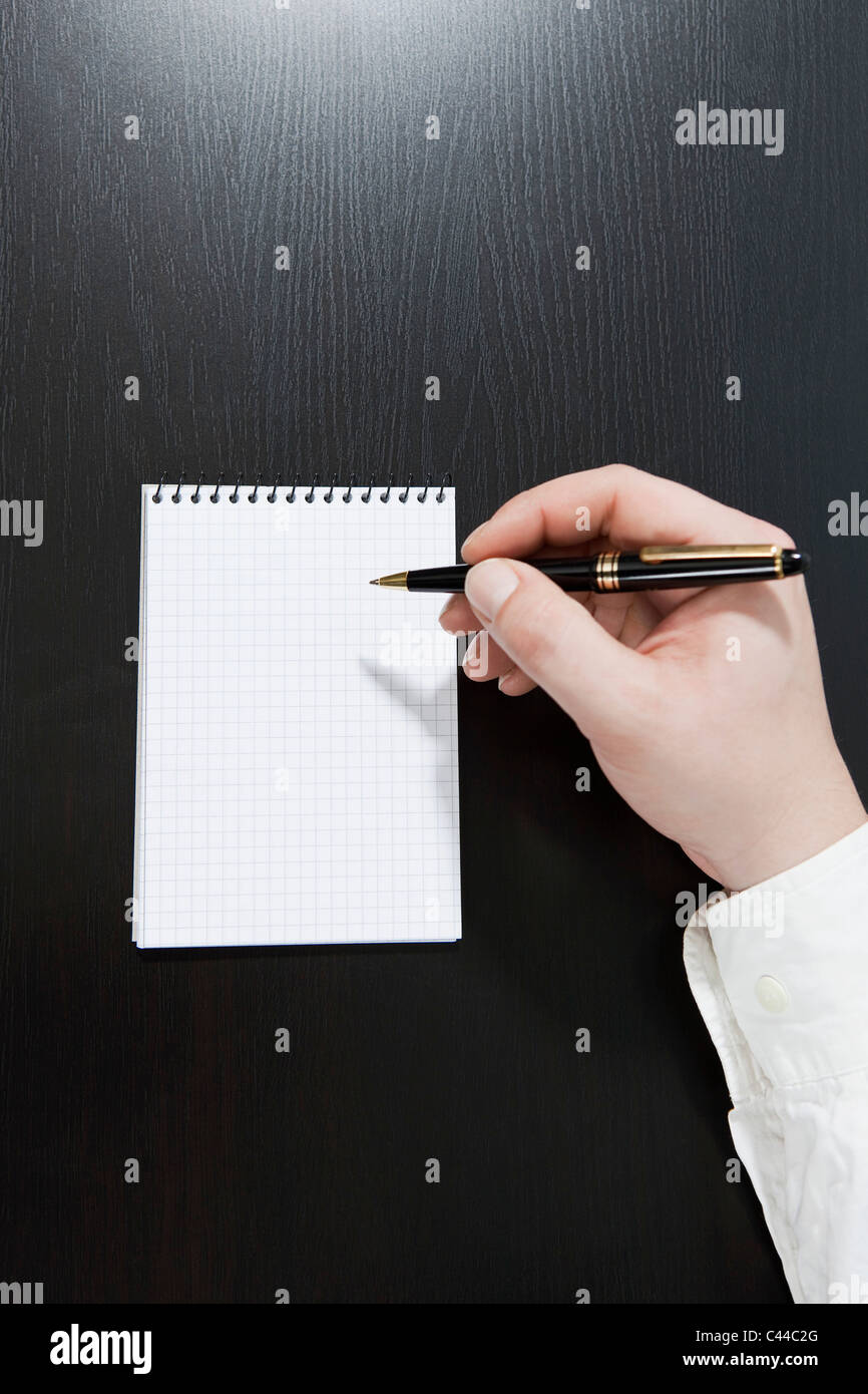 Pen, pad and hand Stock Photo - Alamy