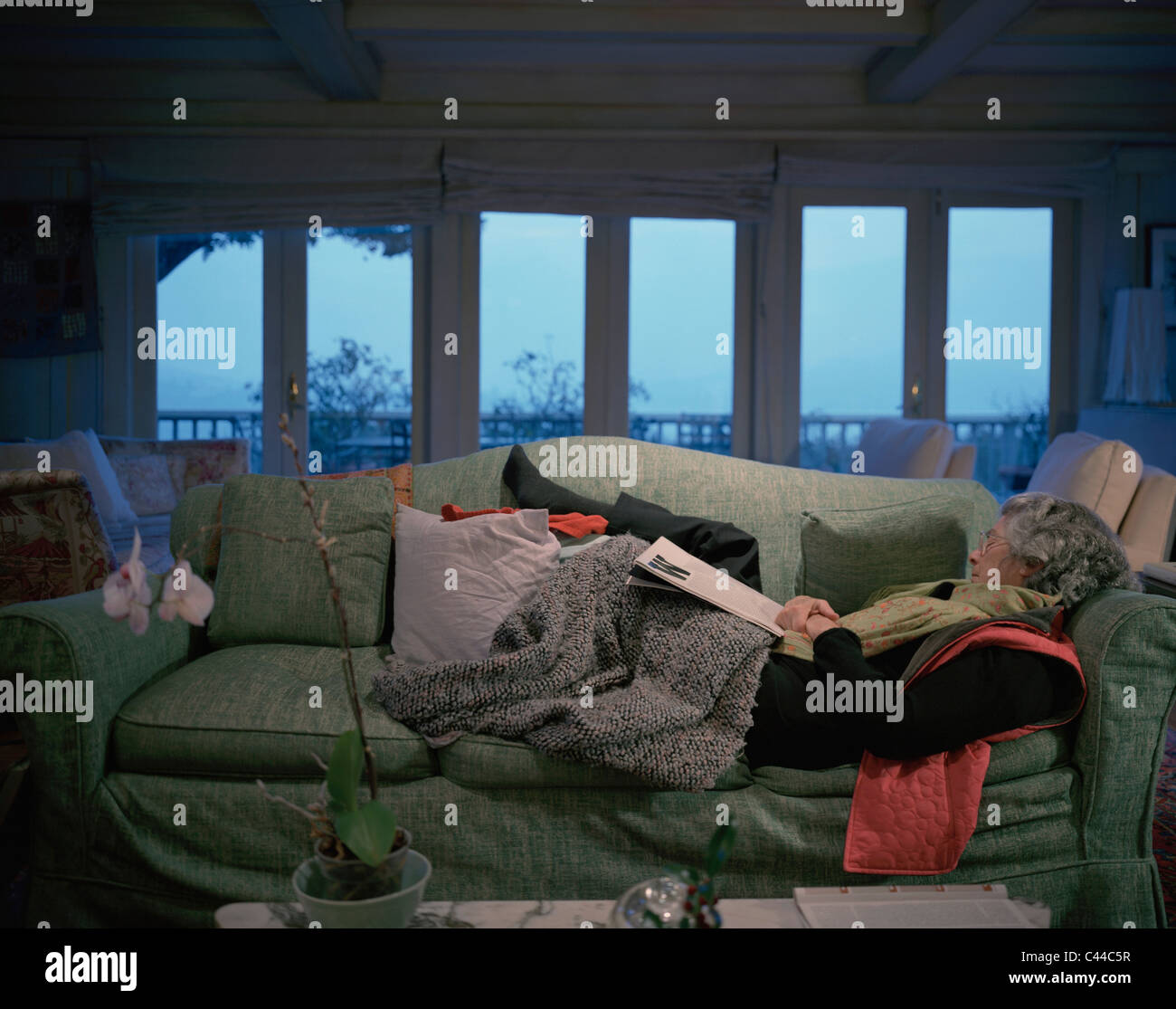 A woman napping on a sofa Stock Photo - Alamy
