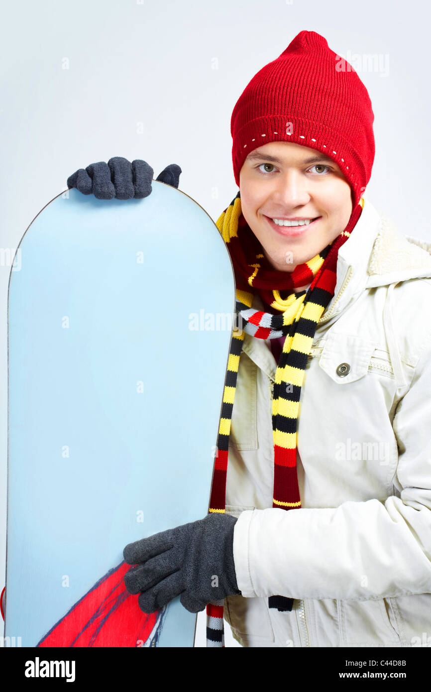 Portrait of healthy man with snowboard looking at camera and smiling ...