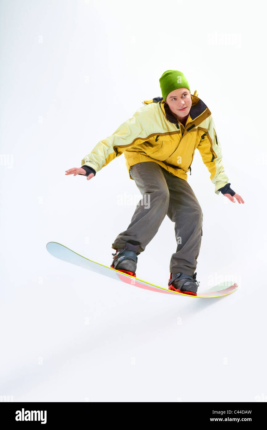 Portrait of young boy snowboarding and looking aside Stock Photo - Alamy