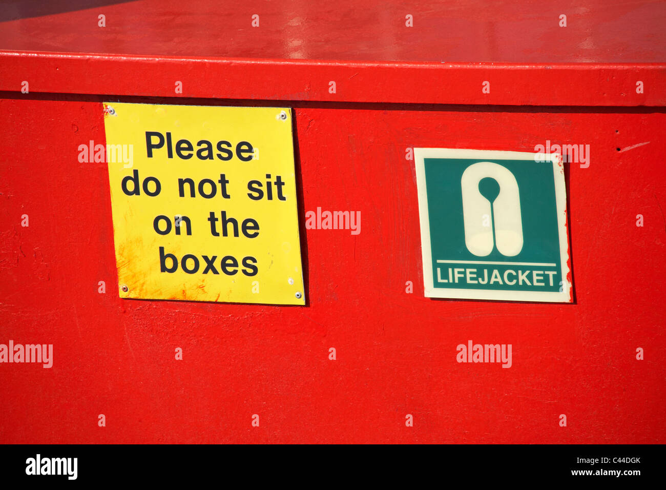 Please do not sit on the boxes sign on box containing lifejackets on ...