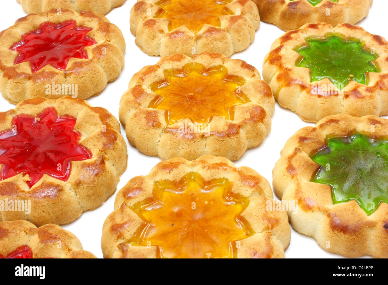 Cookies of yellow color with a stuffing from multi-colored jelly in the ...