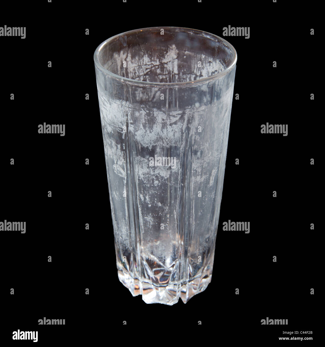Drinking glass showing lime scale damage Stock Photo - Alamy