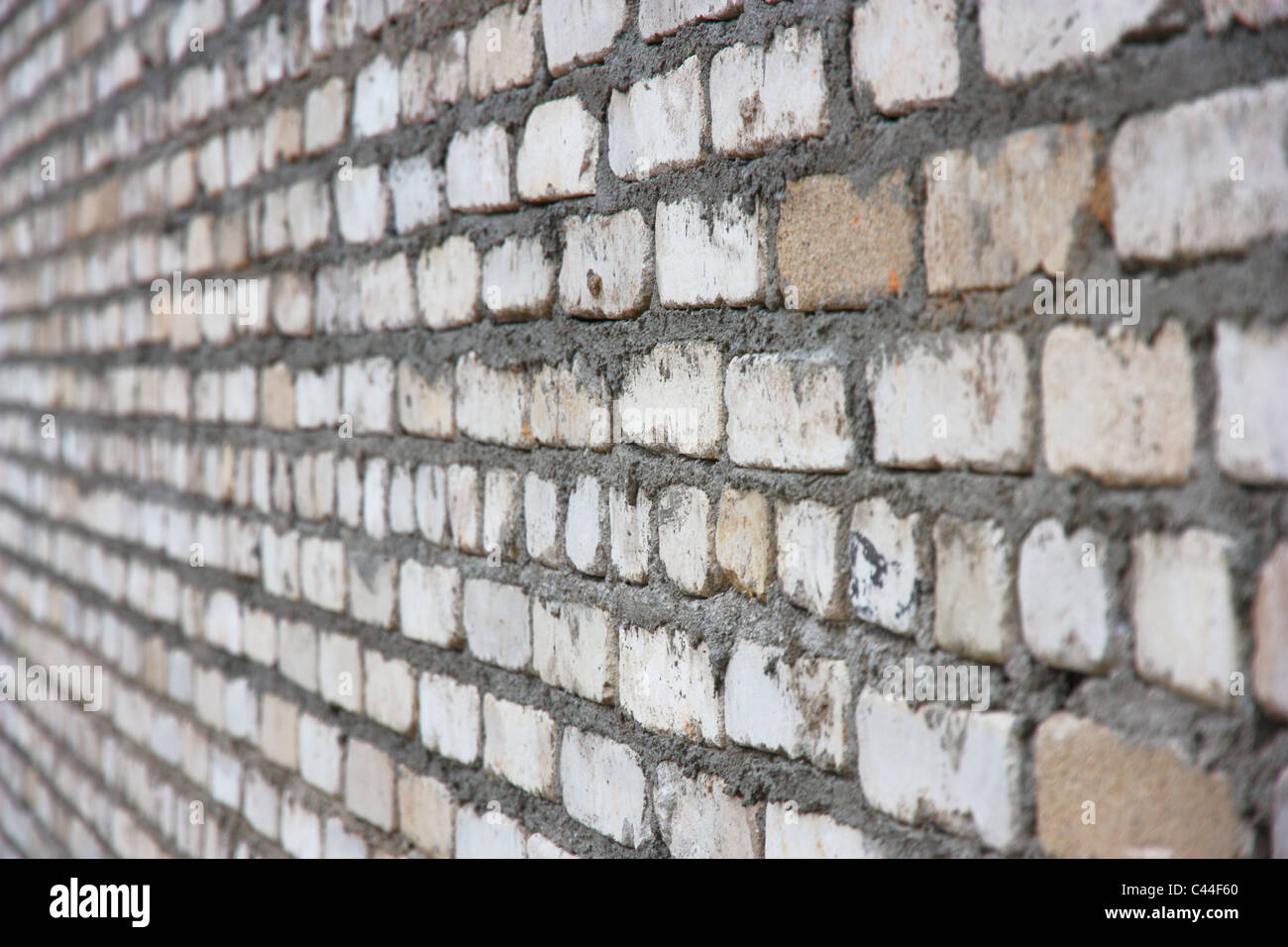 Old white brick wall in a projection leaving in a distance Stock Photo ...