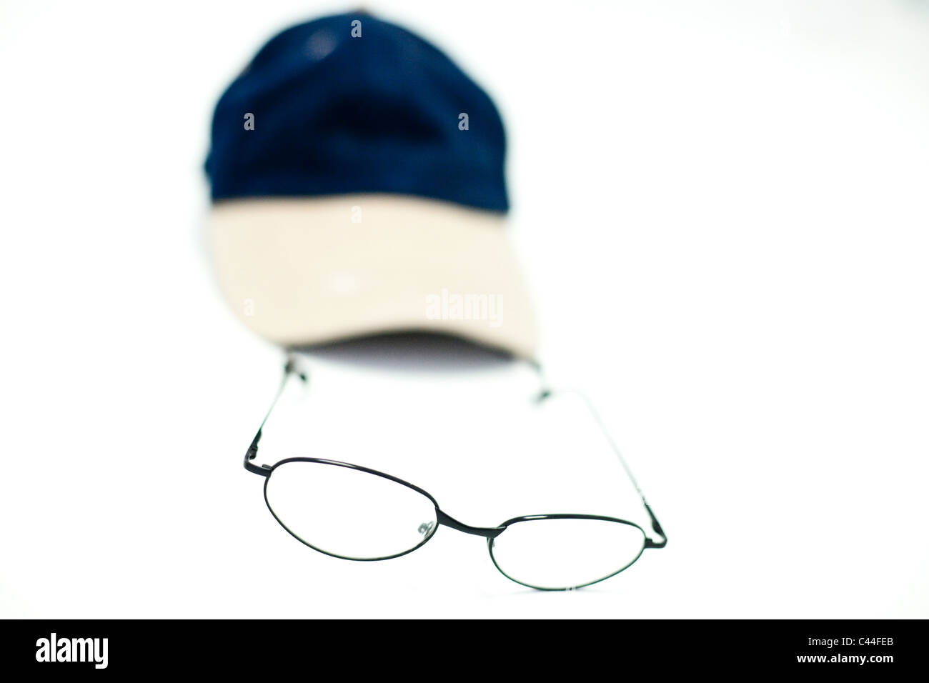 Cap and glasses against white background Stock Photo - Alamy
