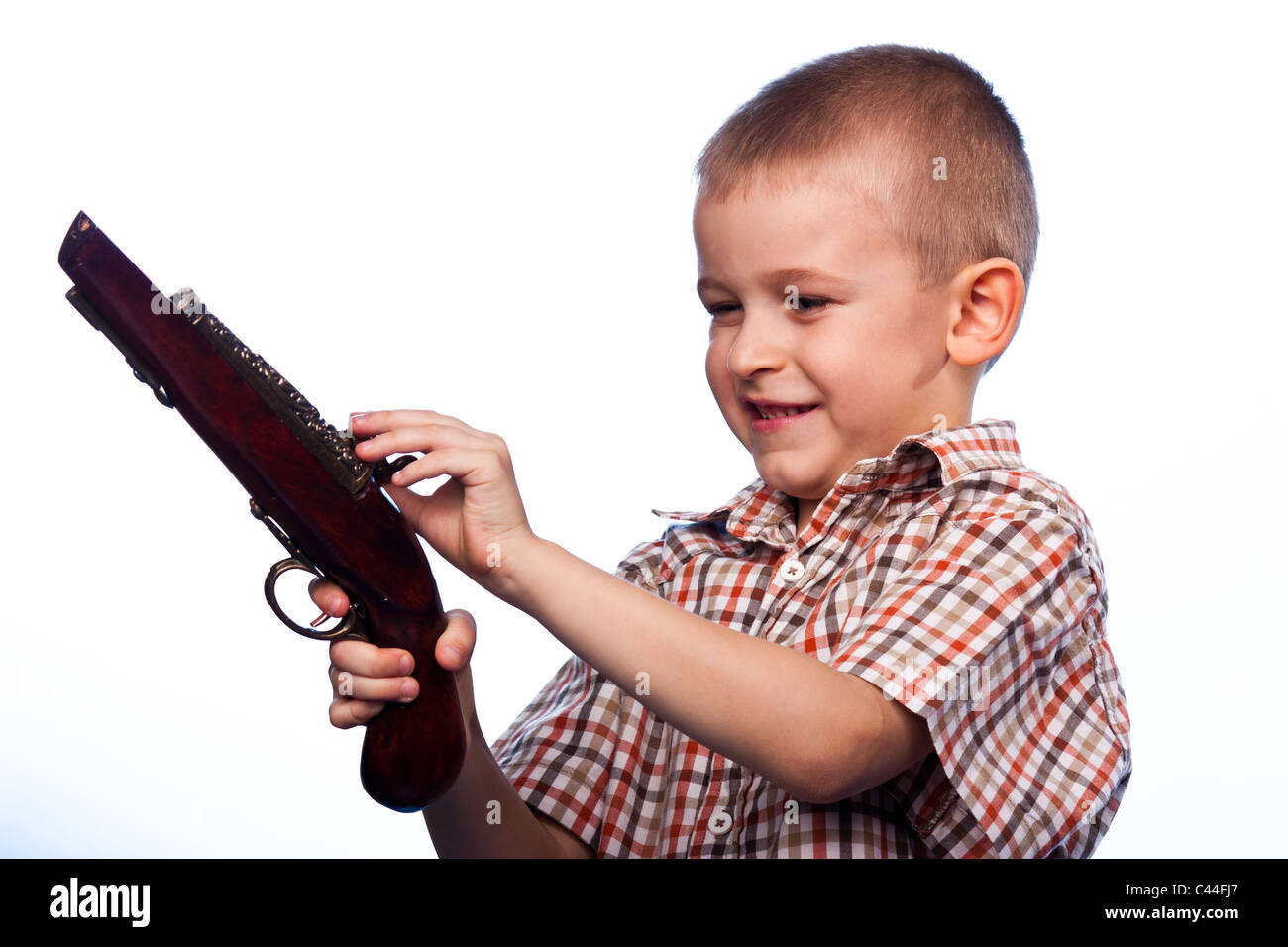Cute boy playing with the gun isolated on white Stock Photo - Alamy