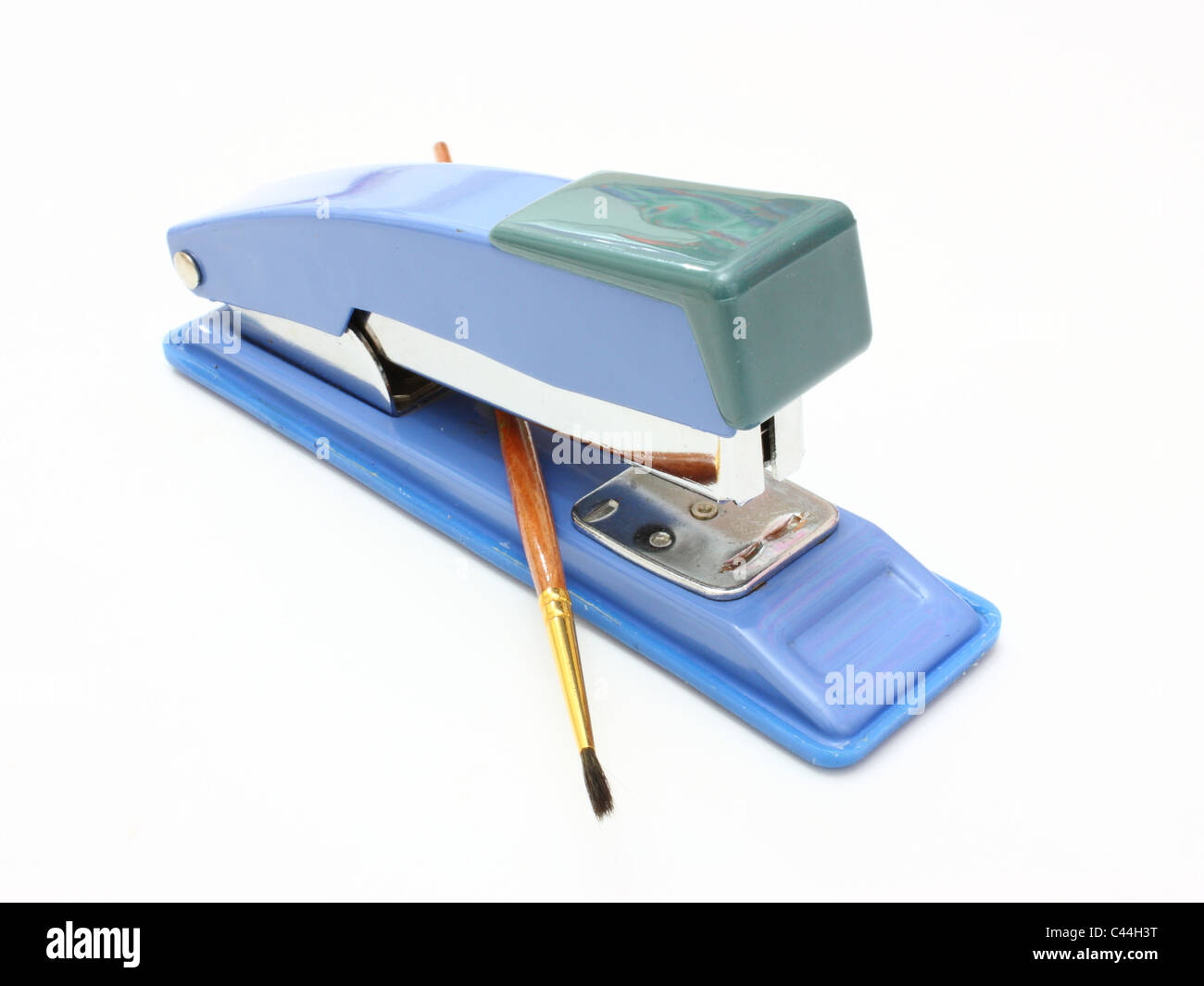 Stapler of dark blue color and brush for paints on a white background ...