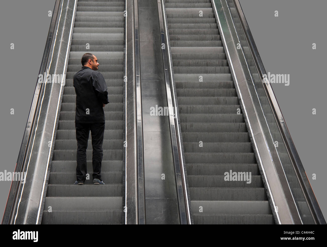 Man going up escalator Stock Photo - Alamy