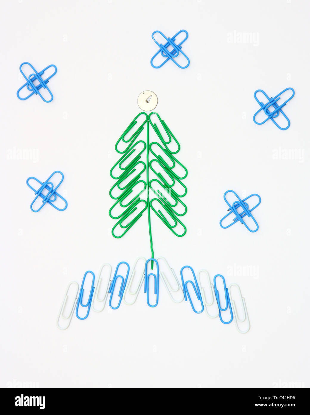 Christmas fur-tree from paper clips for a paper on a white background ...