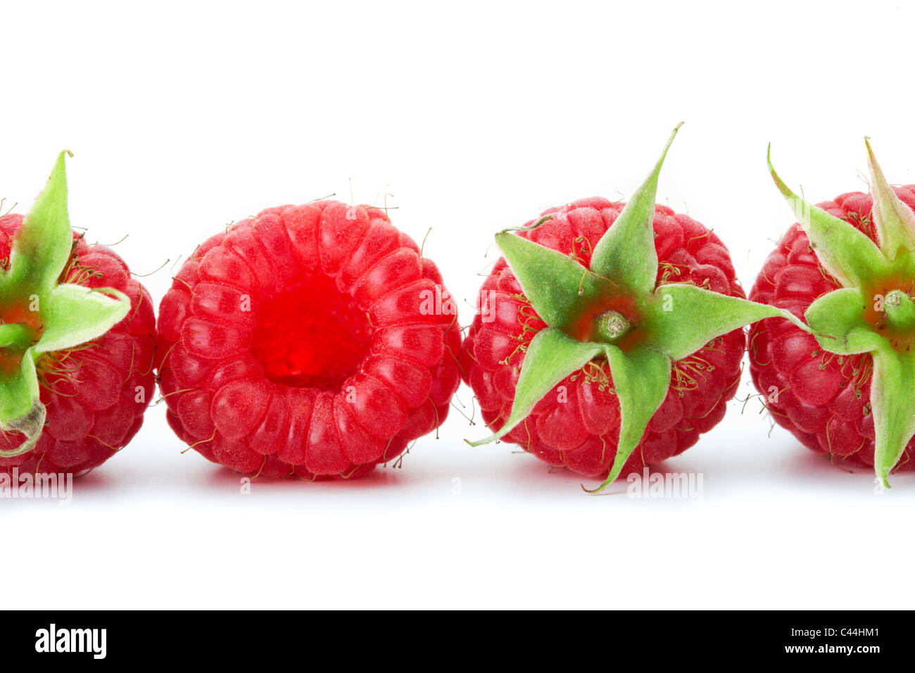 Row of raspberries with green leaves on white Stock Photo - Alamy