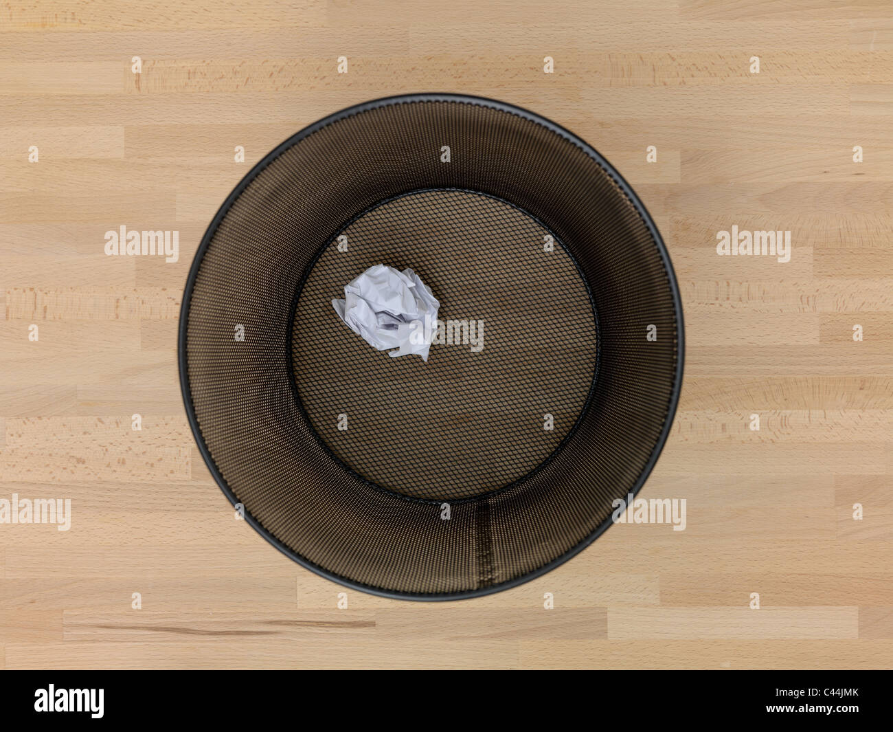 A trash bin isolated on a wooden floor Stock Photo - Alamy