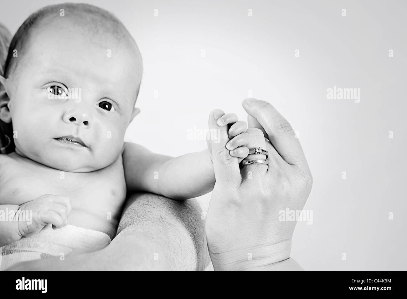 little newborn baby holding his mum's finger Stock Photo - Alamy