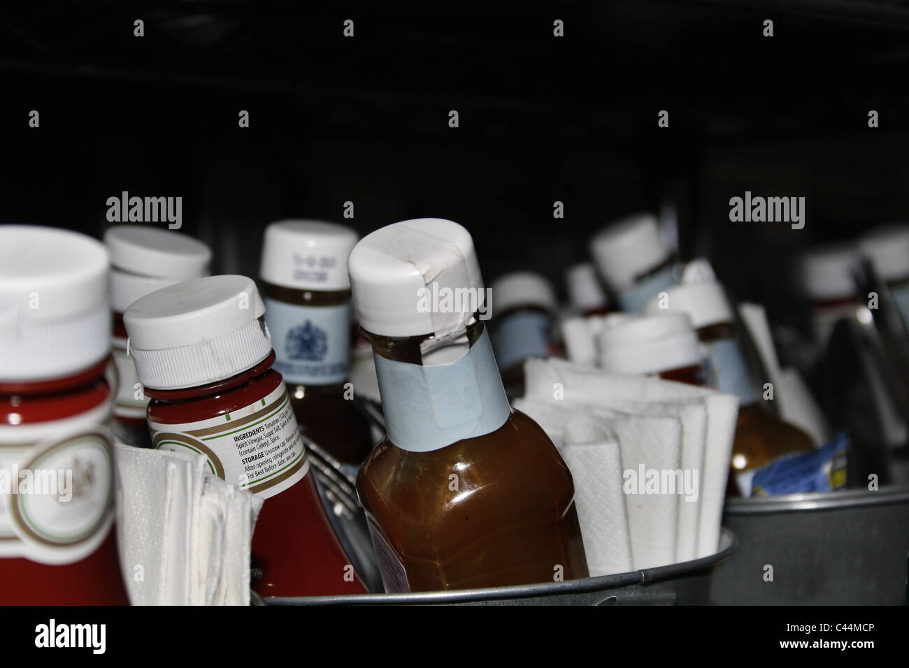 tomato sauce, brown sauce, and cutlery in serving buckets Stock Photo ...