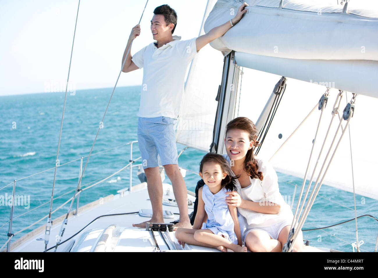 Happy Family On a Sailboat Stock Photo - Alamy