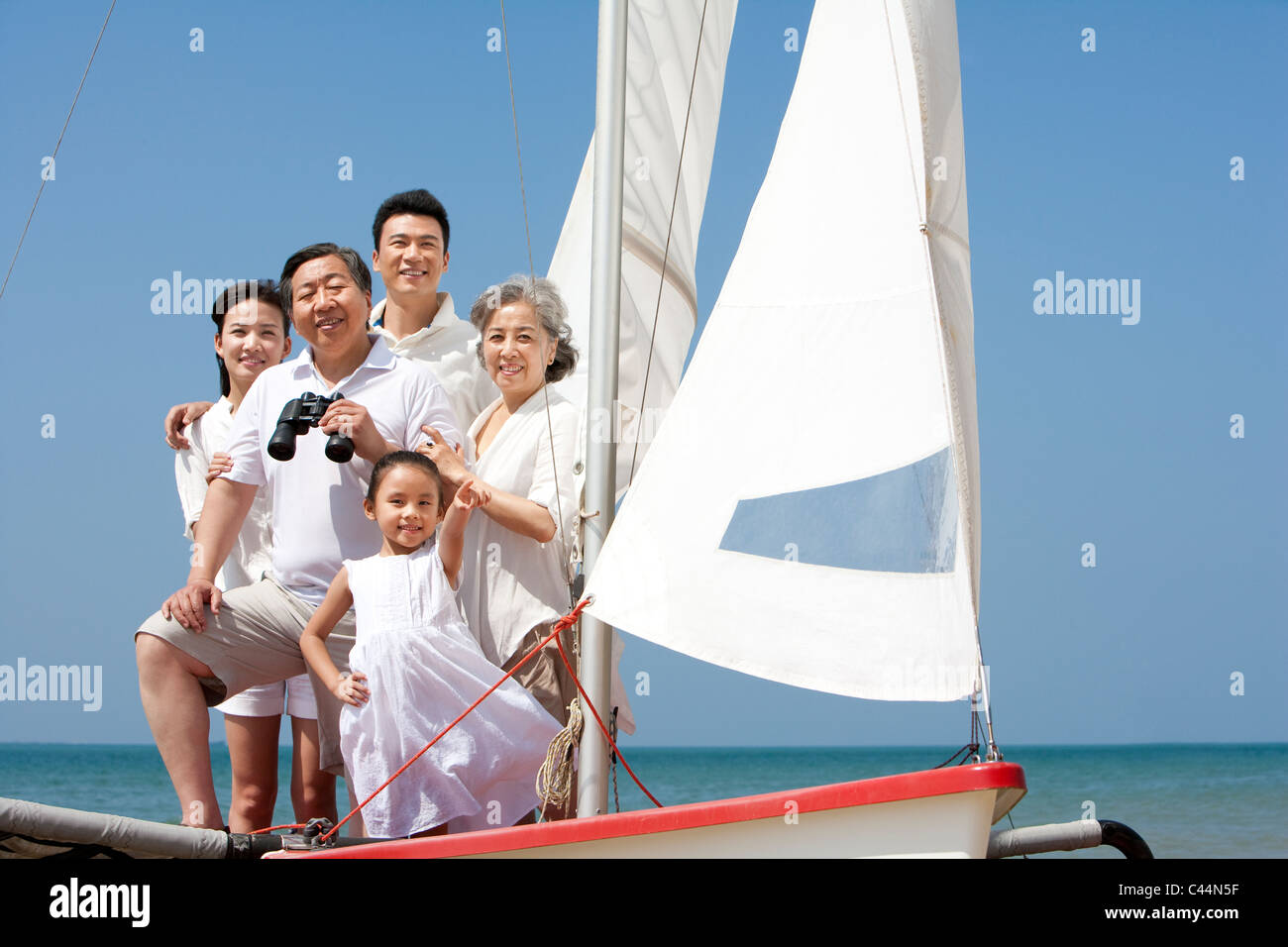 Happy Family On a Sailboat Stock Photo - Alamy