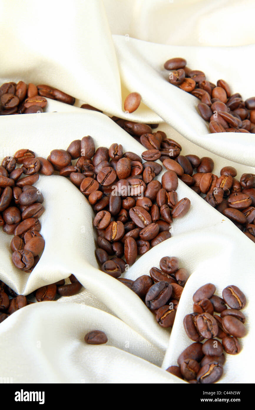 coffee beans on a beige silk concept luxurious coffee Stock Photo - Alamy