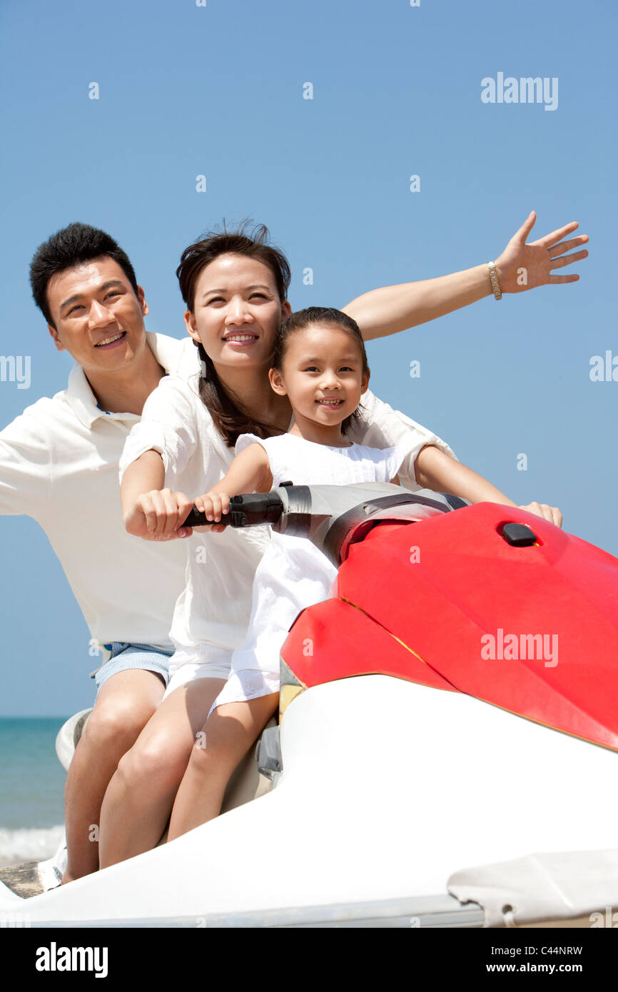 Happy Family Riding a Jet Ski Together Stock Photo - Alamy