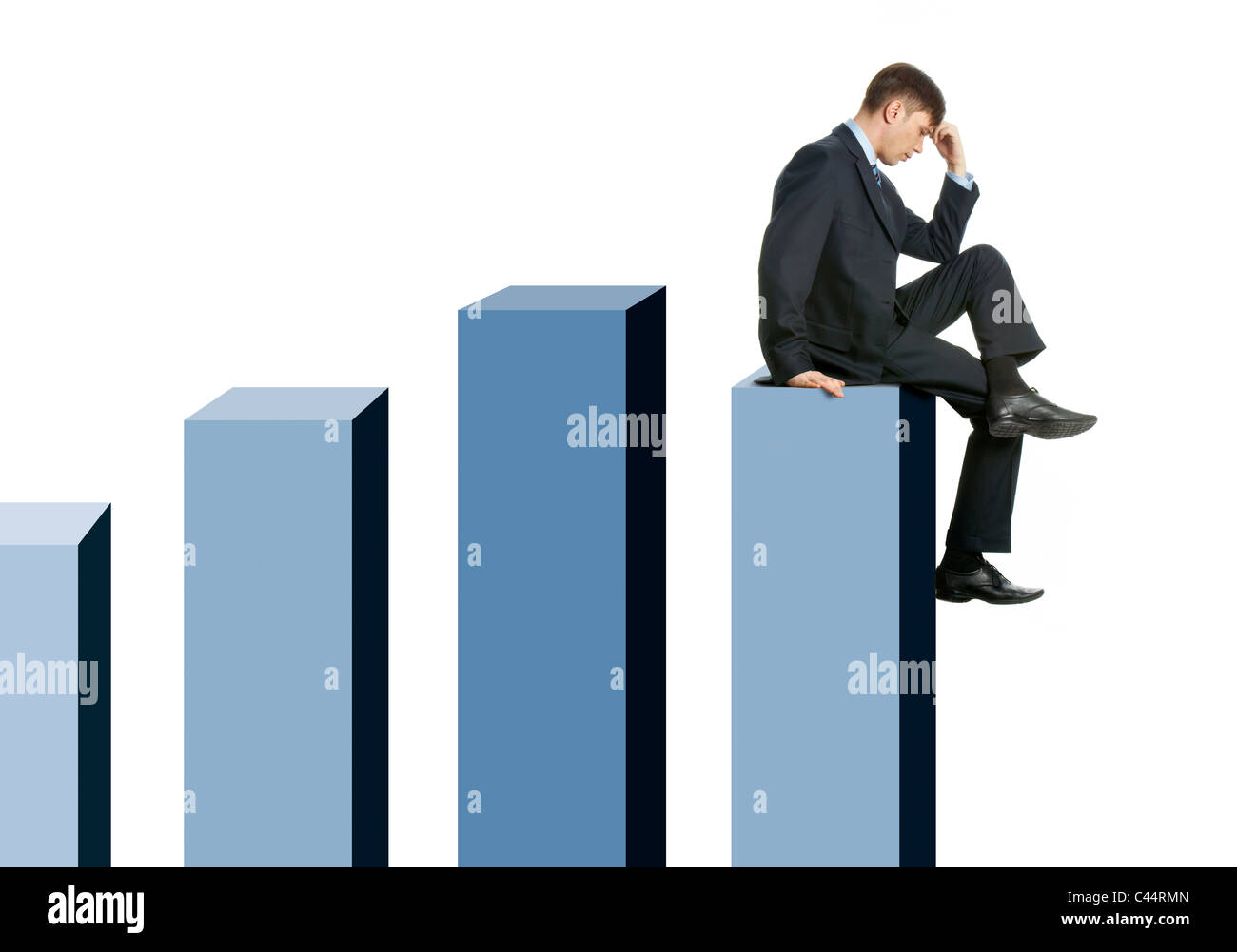 Image of pensive businessman sitting on chart columns Stock Photo - Alamy