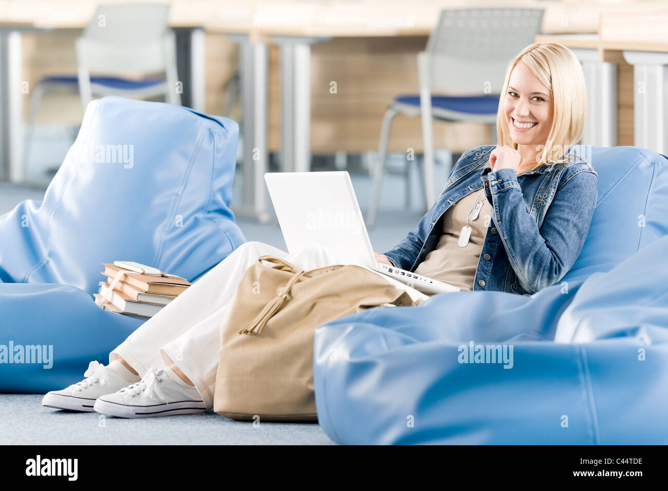 Young happy student girl relaxing at high school with laptop Stock ...