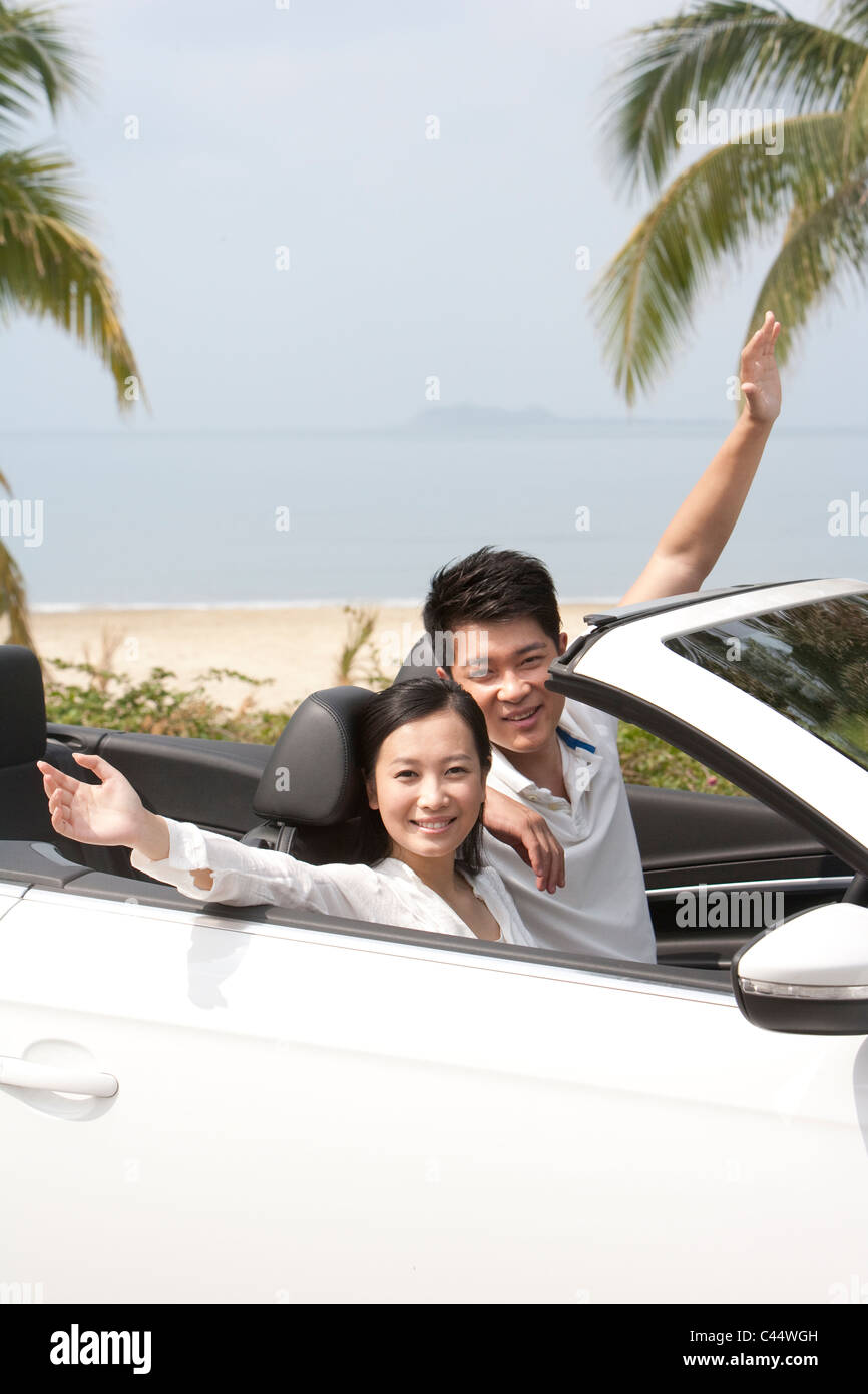 Happy Young Couple Posing in a Convertible Stock Photo - Alamy
