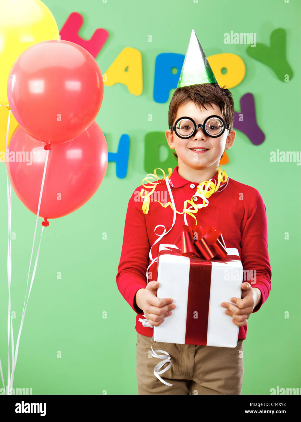 Portrait of happy lad in funny eyeglasses on birthday party with ...