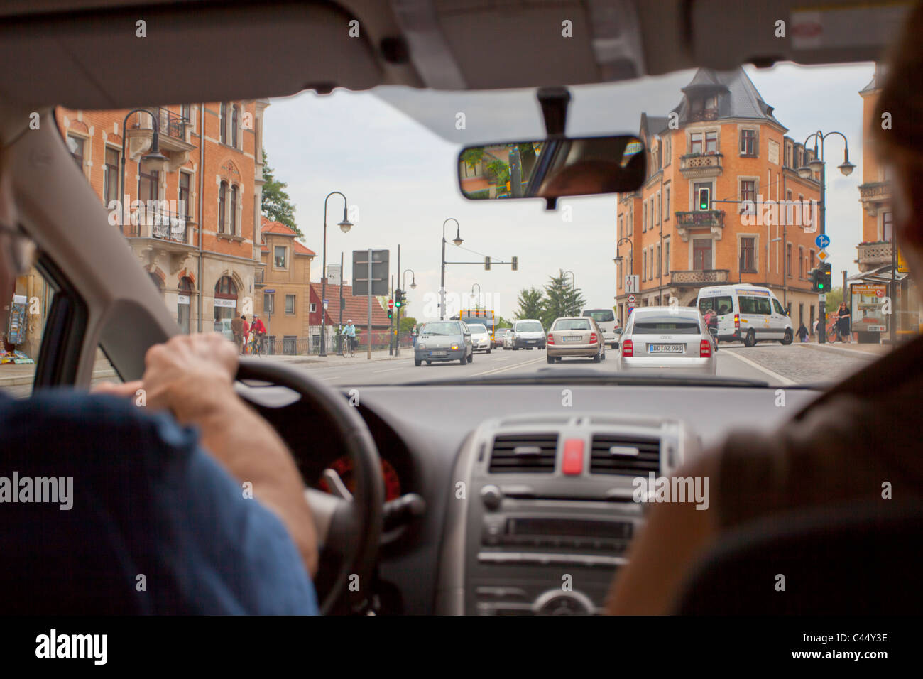 Driver's view on urban road with traffic and historic buildings Stock ...