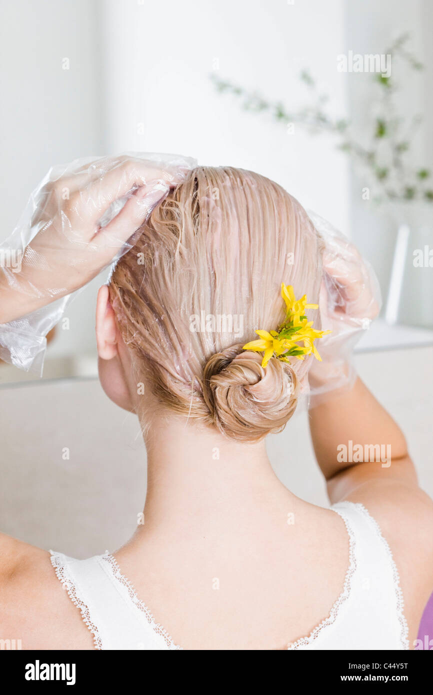 Woman applying hair mask Stock Photo - Alamy