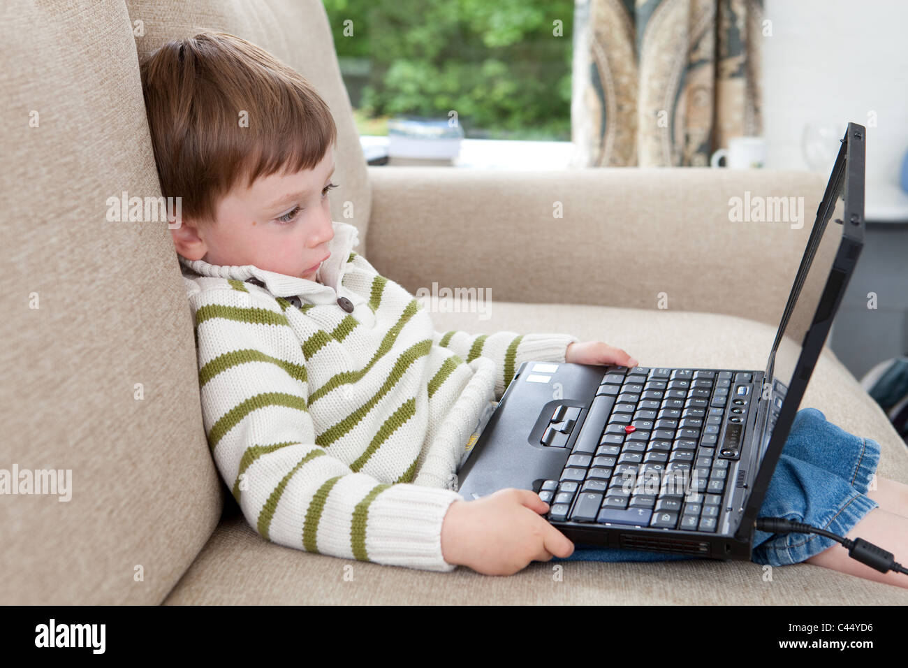 Three year old boy plays with a laptop Stock Photo - Alamy