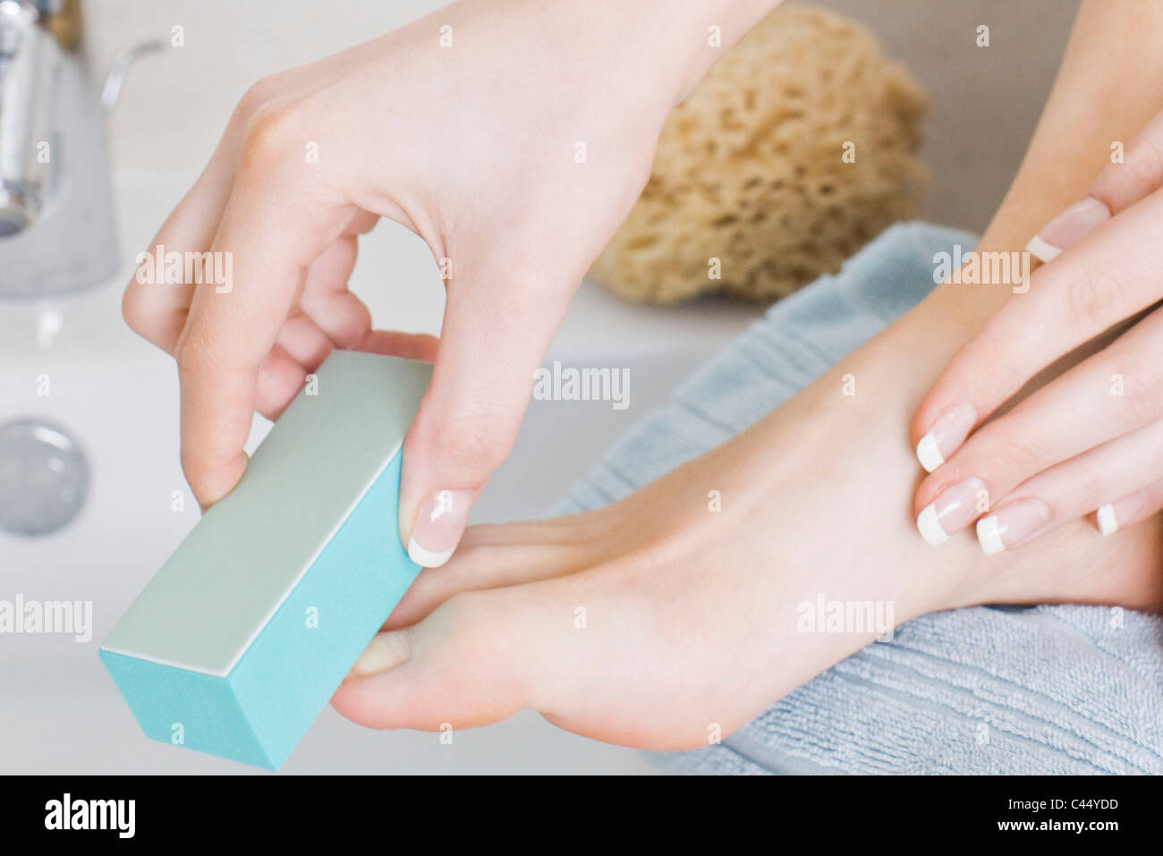 Woman using nail polish for feet Stock Photo - Alamy