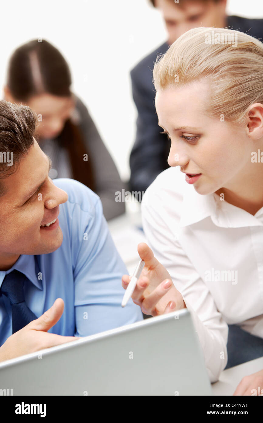 Businesswoman explaining work to businessman Stock Photo - Alamy