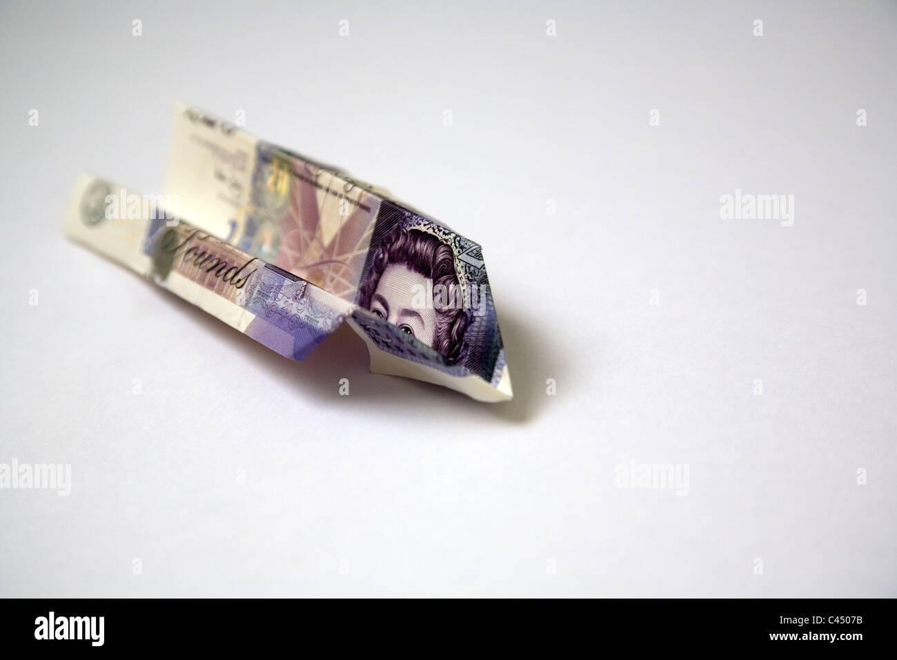 Folded paper, twenty pound note, plane Stock Photo - Alamy