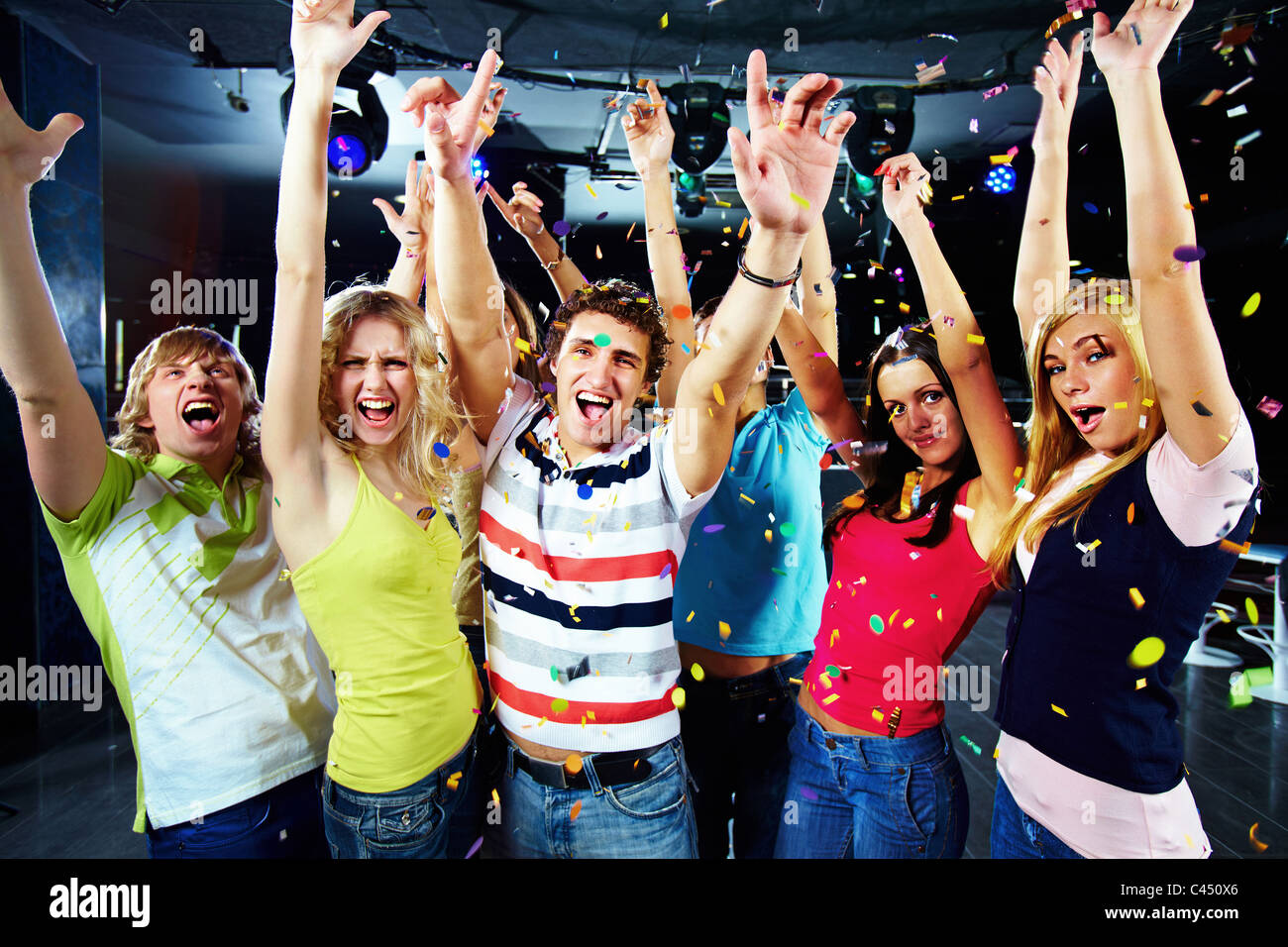 Photo of excited teenagers raising their arms in joy Stock Photo - Alamy