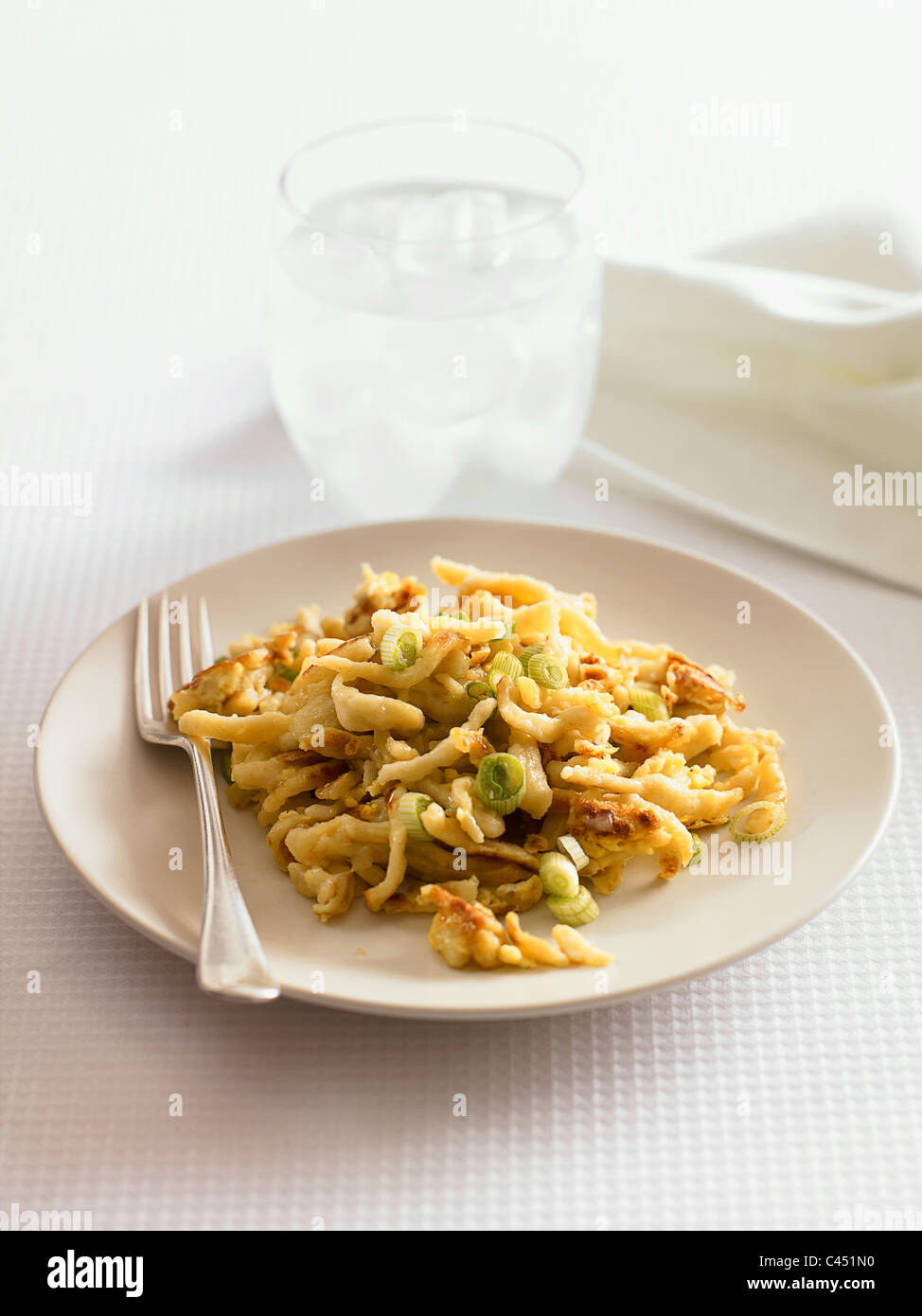 Plate of Kaesespaetzle (Kasspatzen) on white background, close-up Stock ...