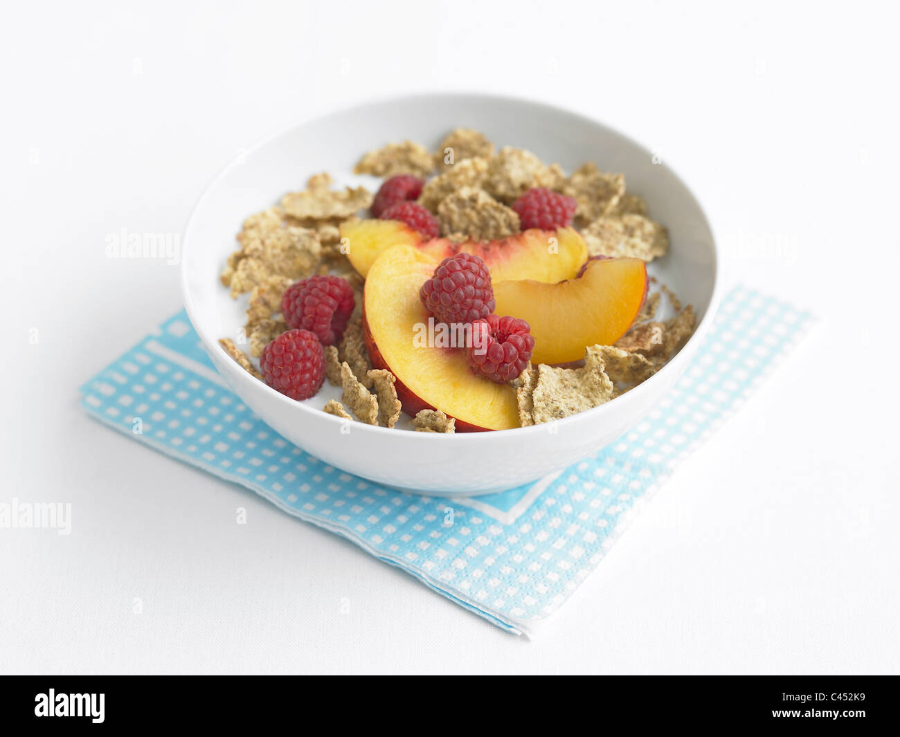 Bran flakes and fruits in bowl with milk, close-up Stock Photo - Alamy