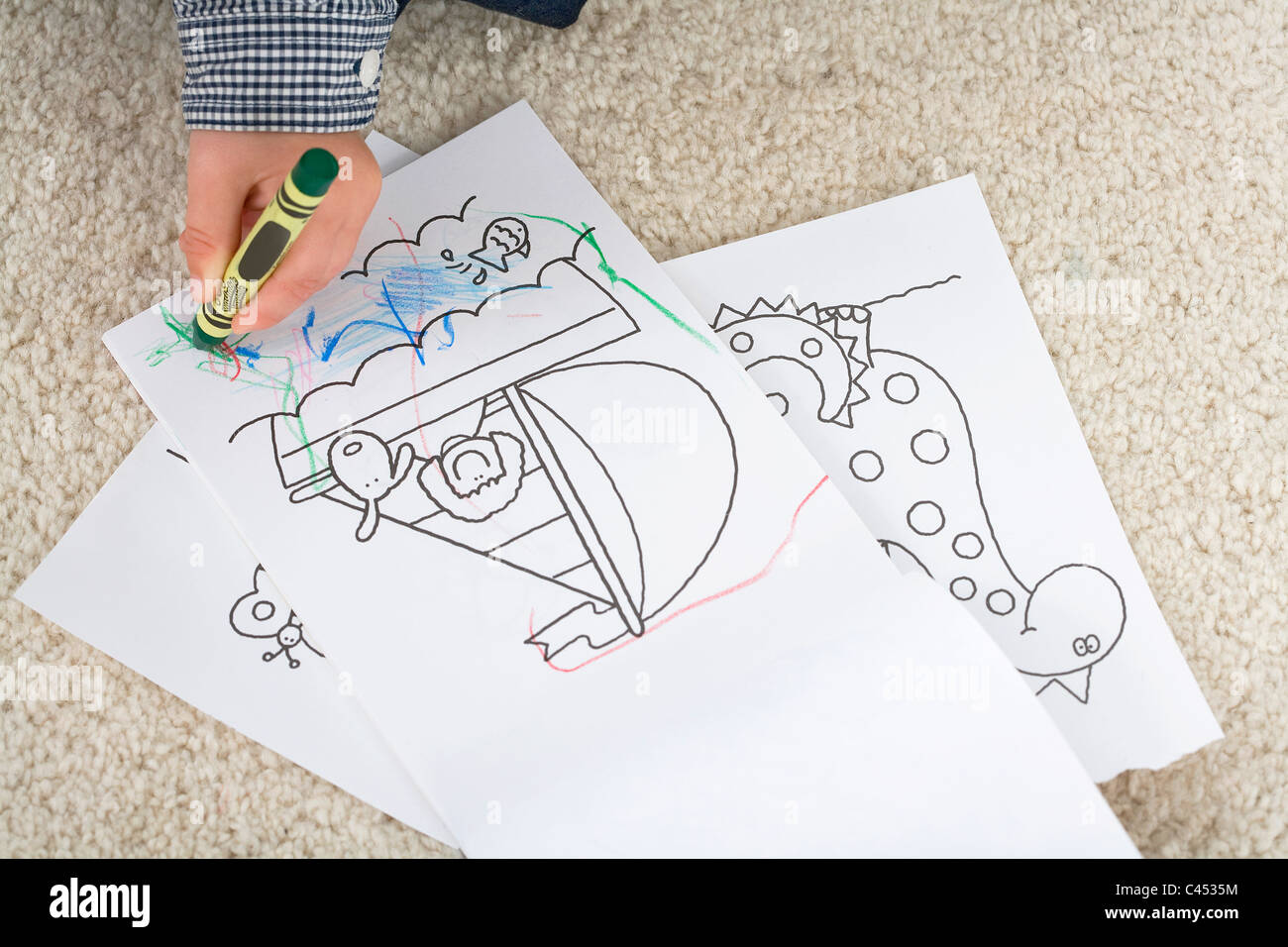 Child colouring picture with crayons Stock Photo - Alamy