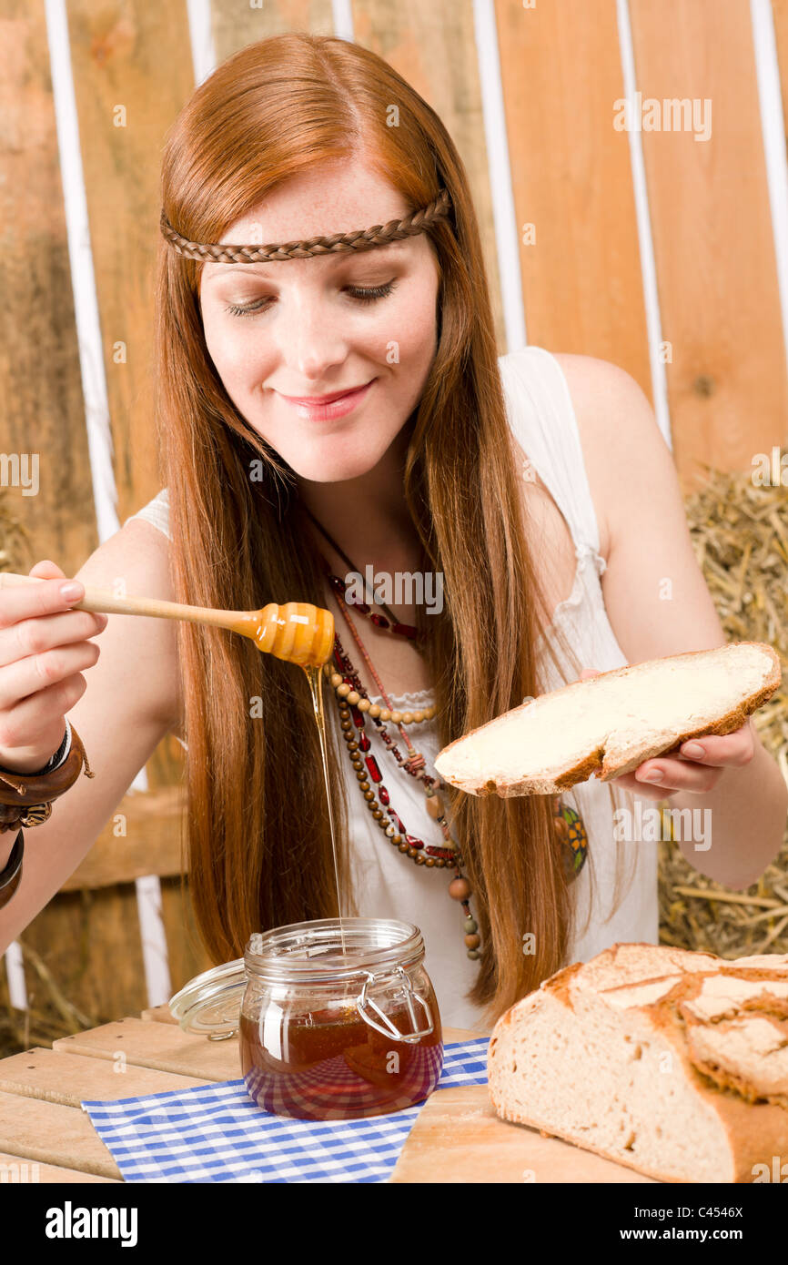 Young red-hair hippie woman organic breakfast in barn country style ...