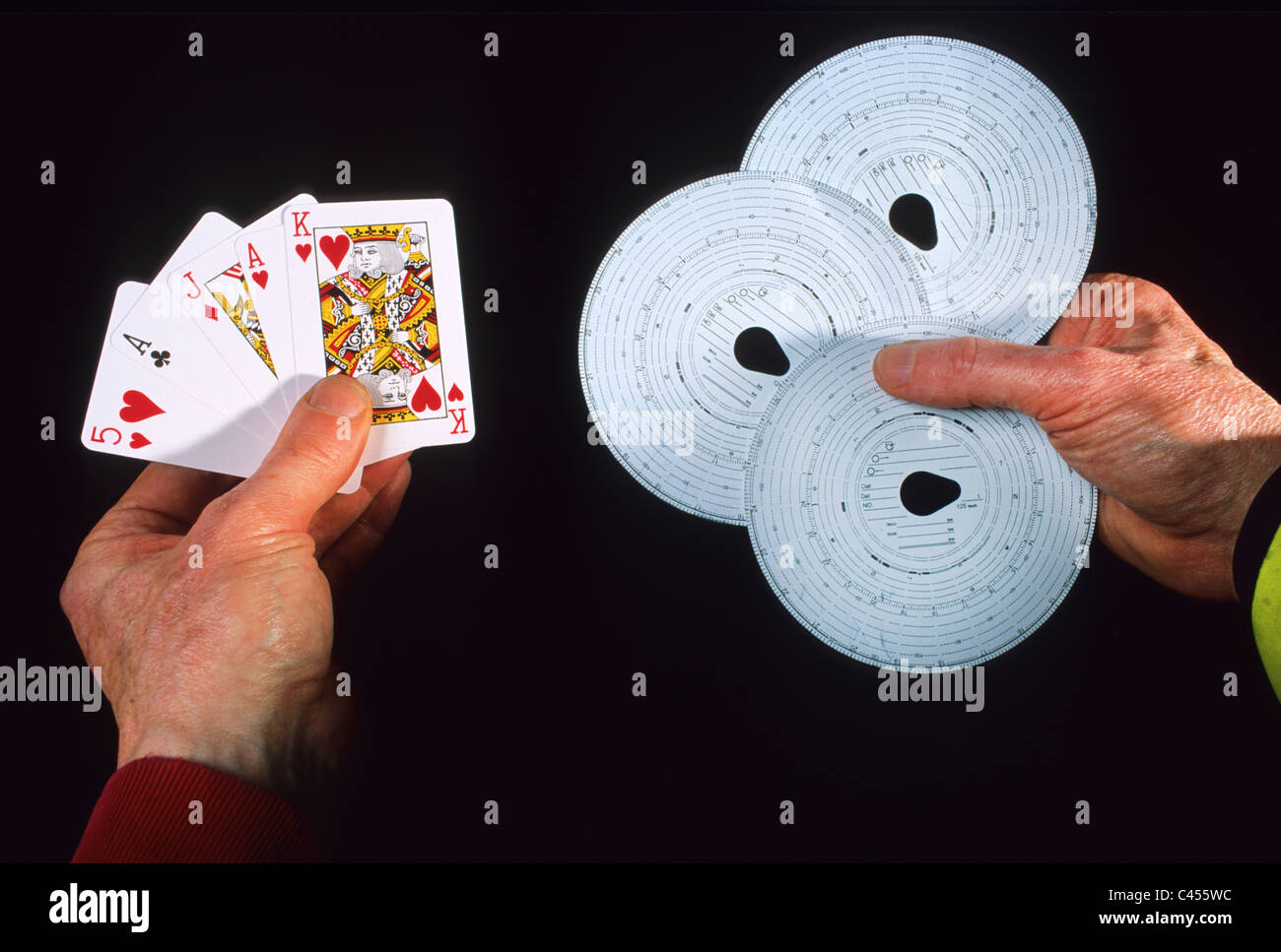 conceptual image of lorry driver holding playing cards and tachometer ...
