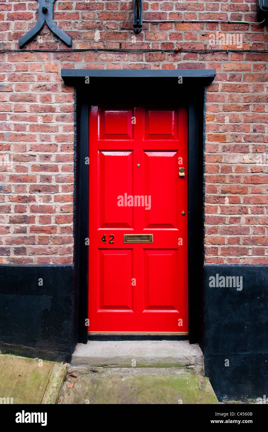 Bright red door set in brick work Stock Photo - Alamy