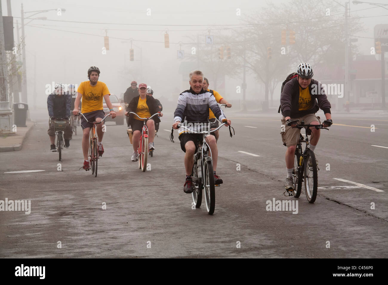 Detroit, Michigan - People ride bicycles to work through early morning ...