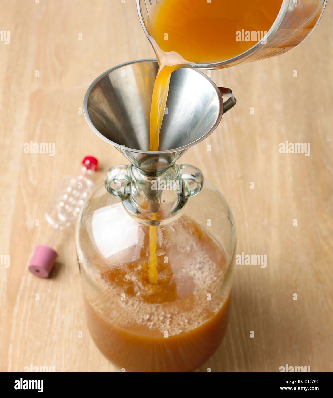 Pouring the cider into the demijohn through funnel hi-res stock ...