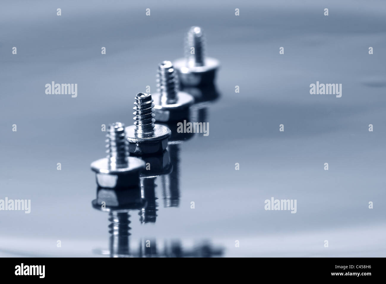Steel screws on dark reflective background Stock Photo - Alamy