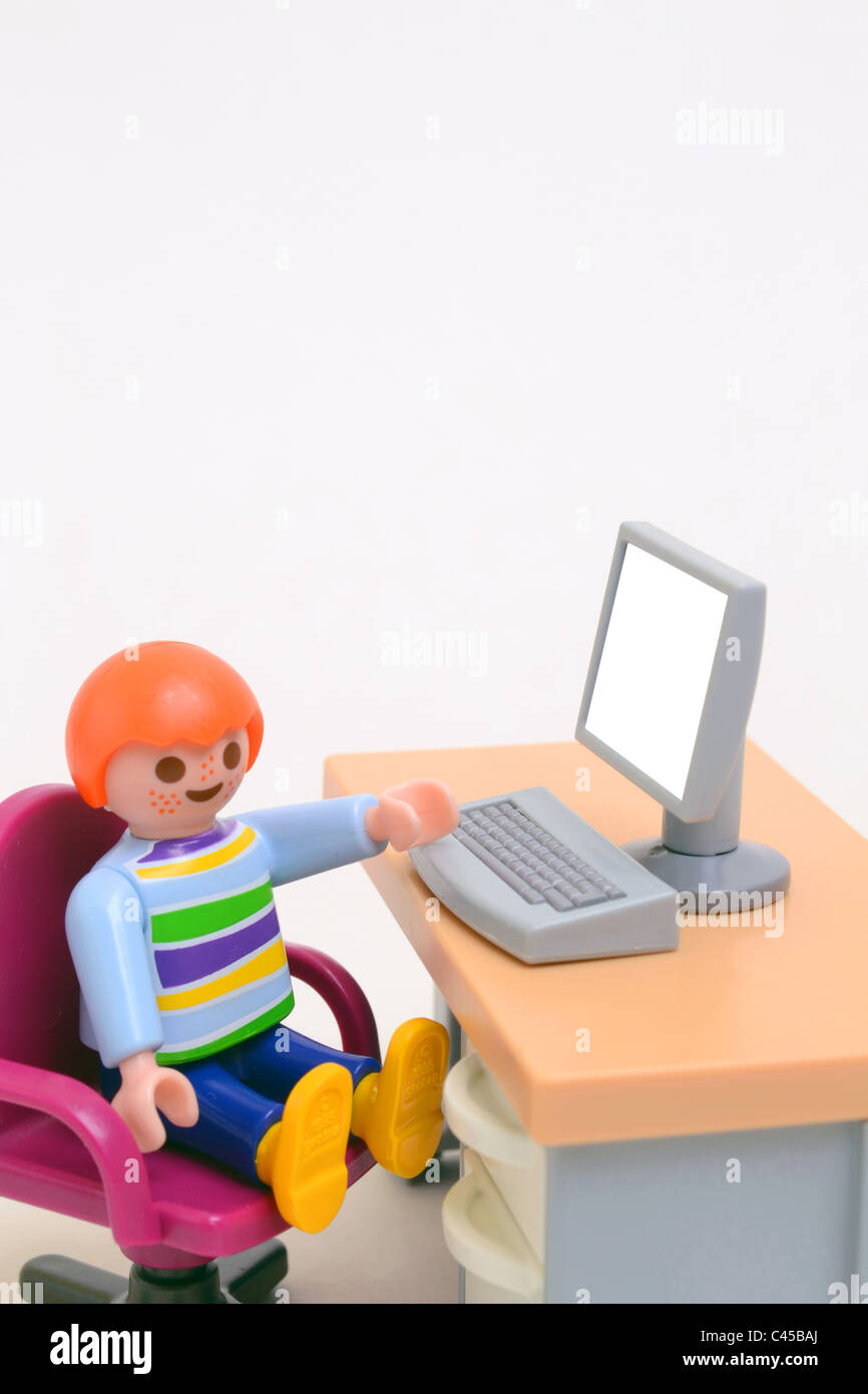 Young child browsing the internet using desktop pc computer concept ...