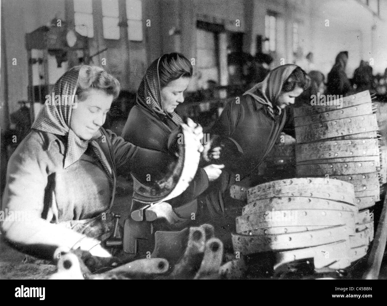 Laborers (Eastern female workers) in a repair station for motor ...