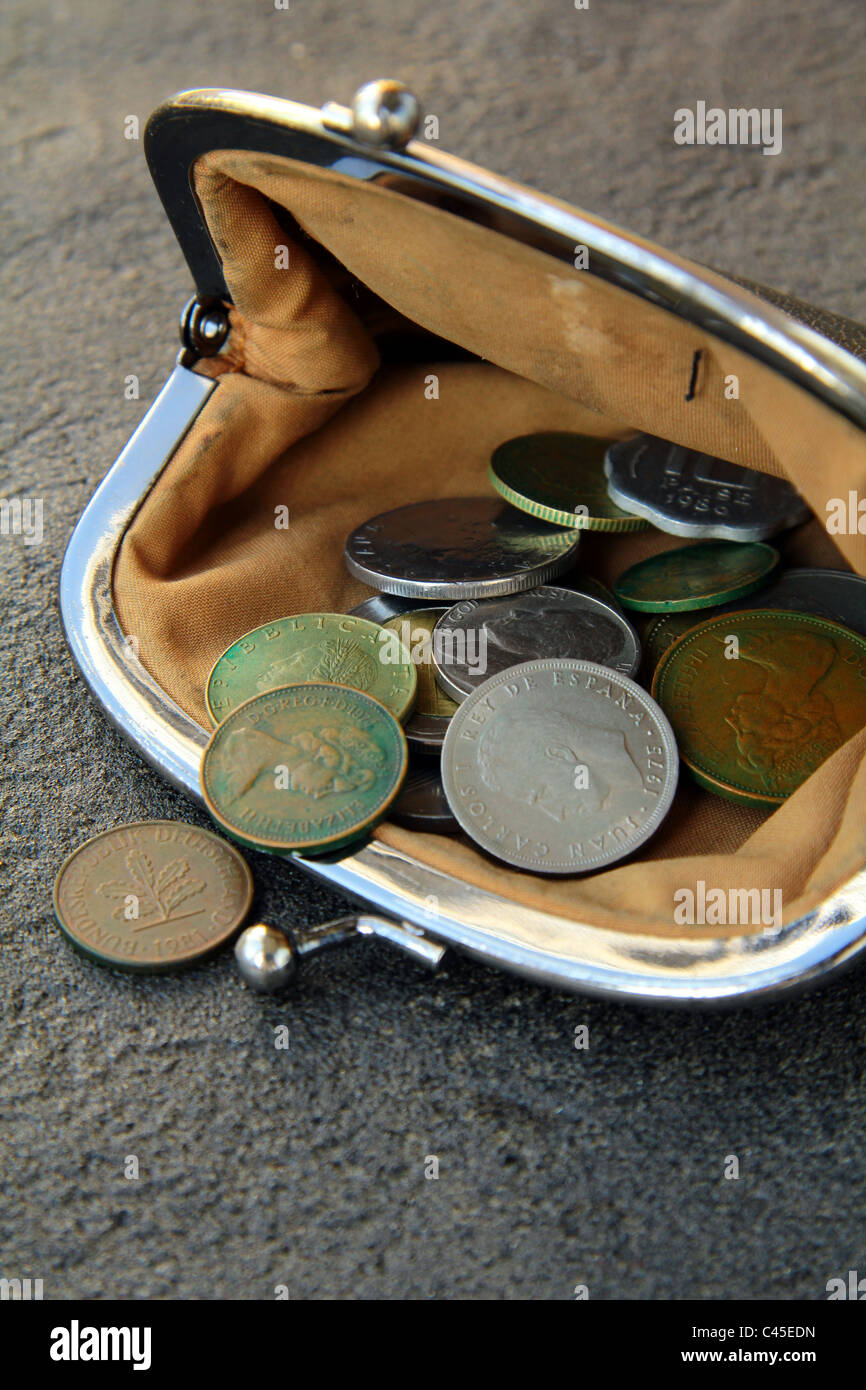 ancient coins in the open vintage purse on a black background Stock ...
