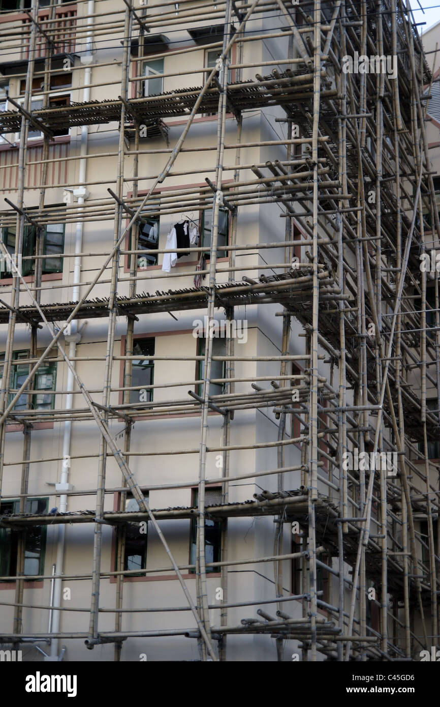 The image shows a scaffolded house in Shanghai, China. The scaffold is ...