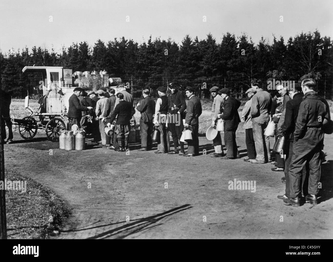 Forced laborer queue up for milk, 1942 Stock Photo - Alamy