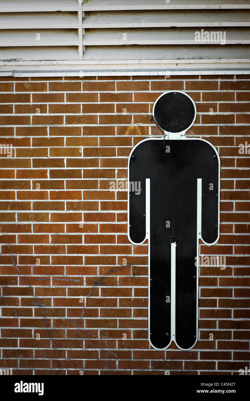 A human male symbol affixed to a red-brick wall Stock Photo - Alamy